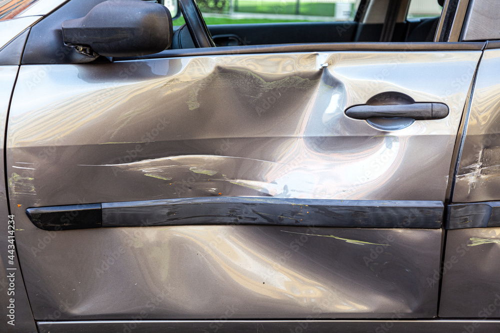 Side view of destroyed car after crash, closeup of dents and scratches ...