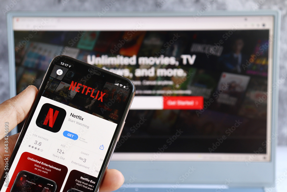 Netflix logo on computer screen and Netflix logo on smartphone screen ...