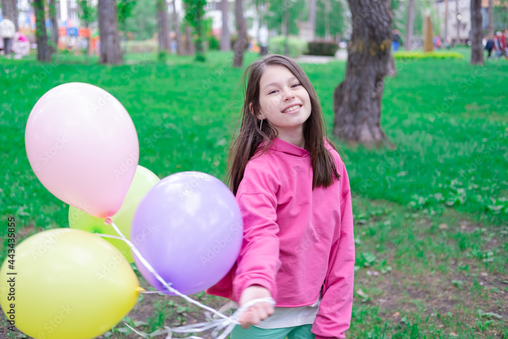 pretty tween teenager brunette girl in pink holding colorful hot air ...