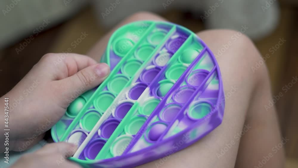 The Child Clicks The Popit Toy. Close-up of the Child's Hands and Pop ...
