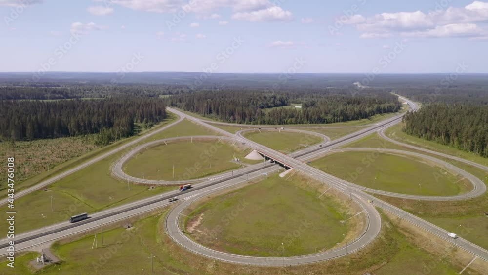 Flight around large highway clover junction in the wood with cargo ...