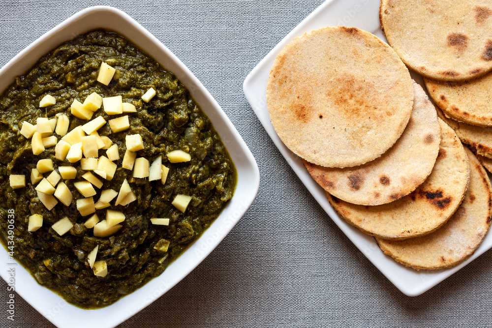 Mustard greens dish with corn roti flatbreads. Vegan Indian meal (Makki ...