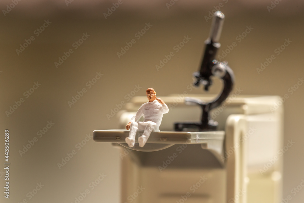 A human figurine sitting on a medical trolley , medical staff figurine ...