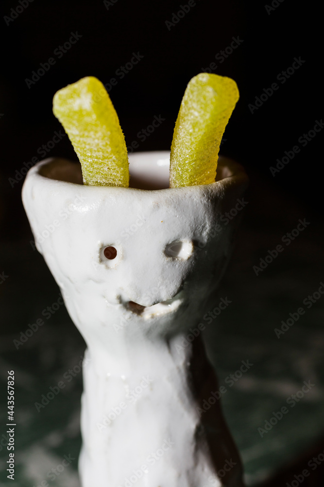 Smiley face clay sculpture with green antennas Stock Photo | Adobe Stock