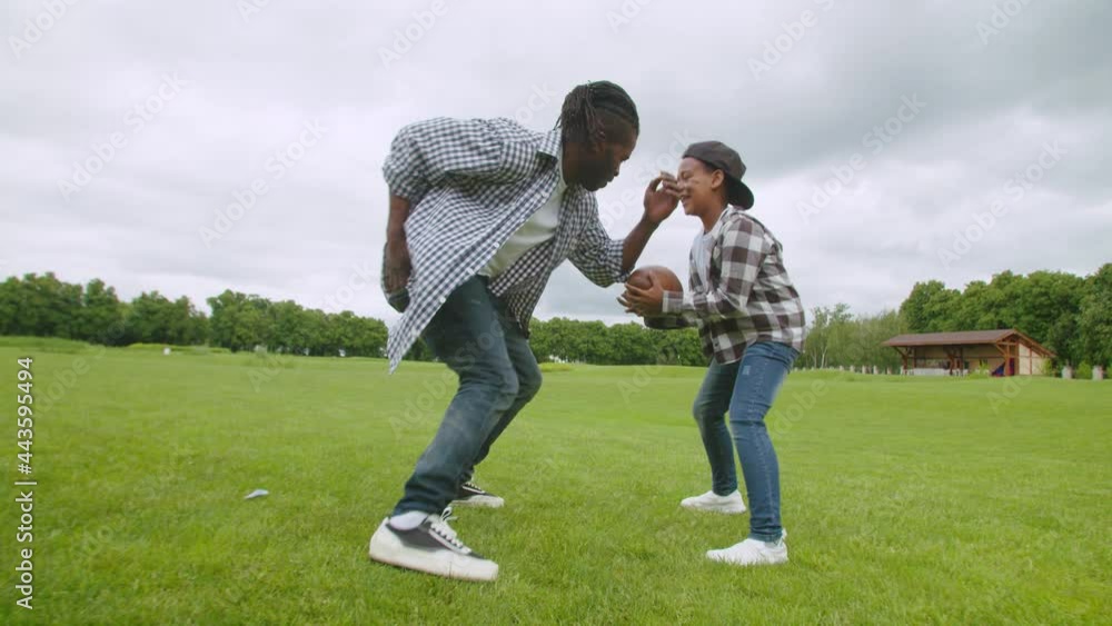 Side view of joyful cute school age black man carrying american ...
