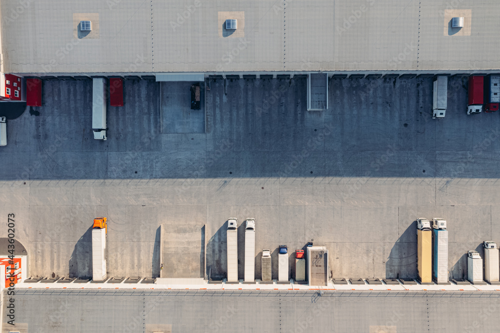 Trucks with trailers wait for the loading of goods for transportation ...