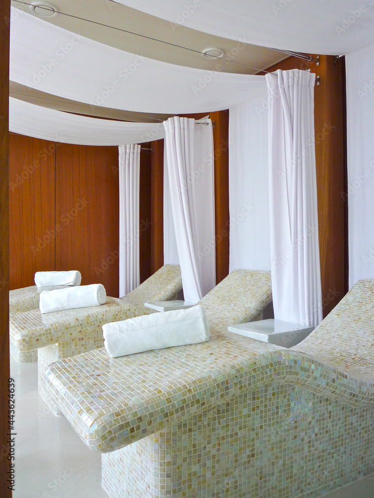 Relaxation room heated mosaic tile loungers inside spa or wellness area ...