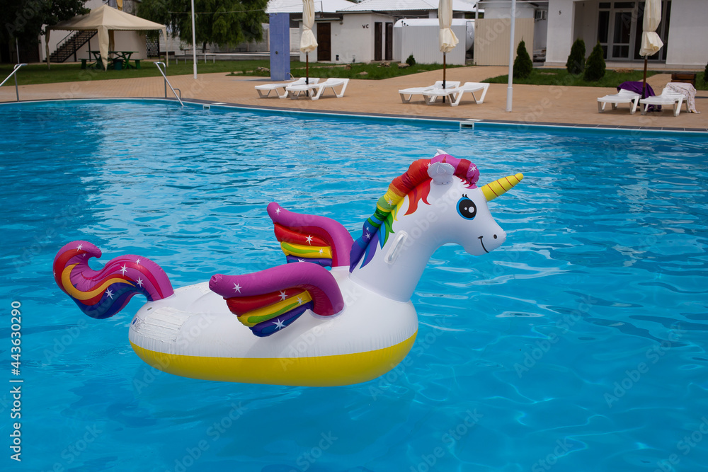 Unicorn pool float in blue water background, inflatable swim tube. Pool ...