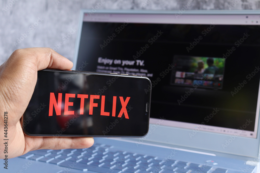Netflix logo on computer screen and Netflix logo on smartphone screen ...