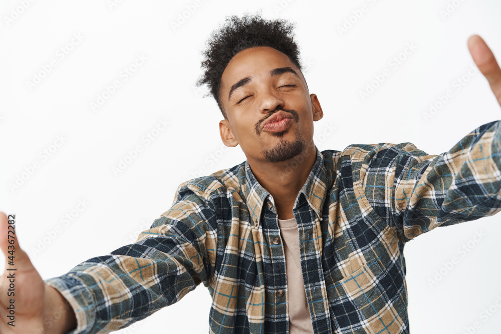 Portrait of handsome silly african american man, close eyes and pucker ...