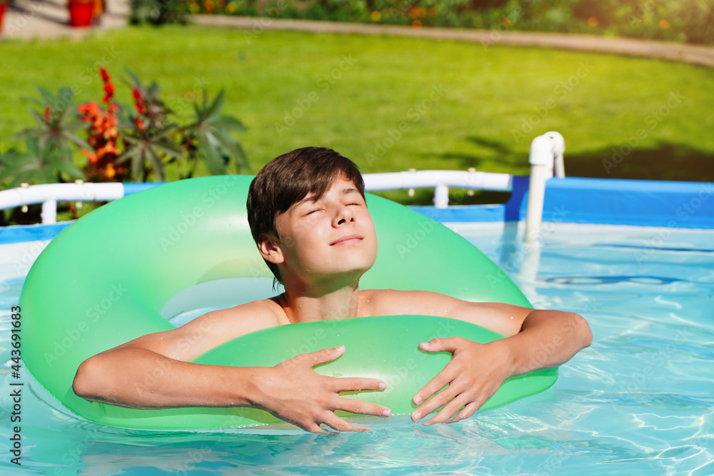 Summer pool with green circle and laughing guy sunbathing. Children in ...