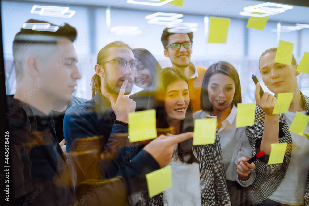 Sharing ideas concepts with papernote writing strategy on wall glass ...