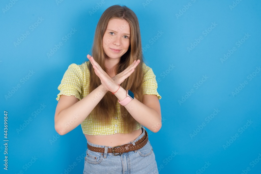 young beautiful blonde woman standing against blue background Has ...