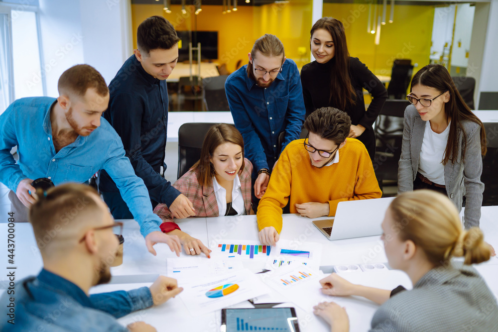 Successful team. Group of young businessmen working and communicating ...
