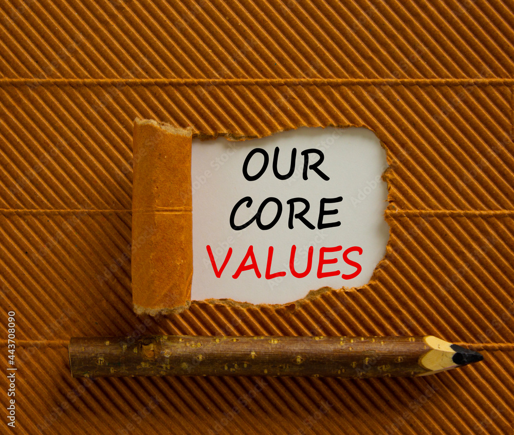 Our core values symbol. Words 'Our core values' appearing behind torn ...