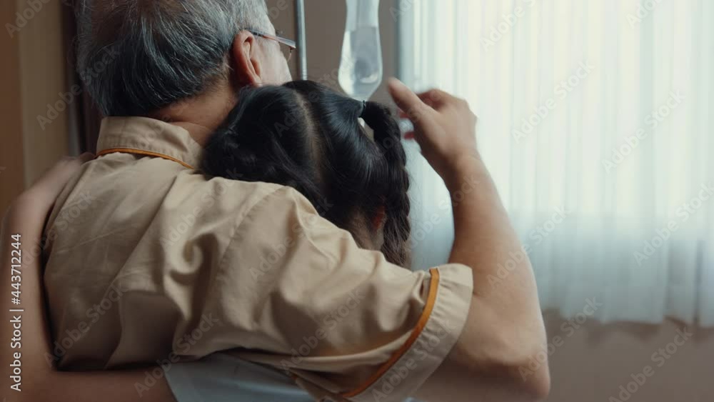 Vídeo do Stock: Little girl Asian granddaughter visiting hug sick ...