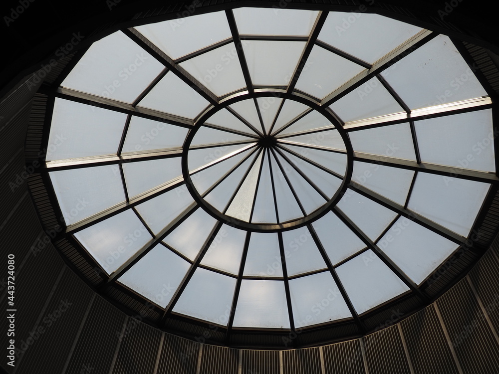 Glass dome or round window in the roof. The sky can be seen through a ...