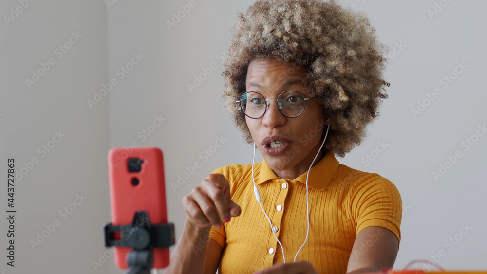 Black blogger woman recording video for social networks with a mobile ...