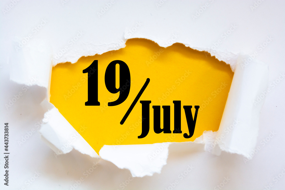 July 19. 19th day of the month, calendar date. Hole in paper with edges ...