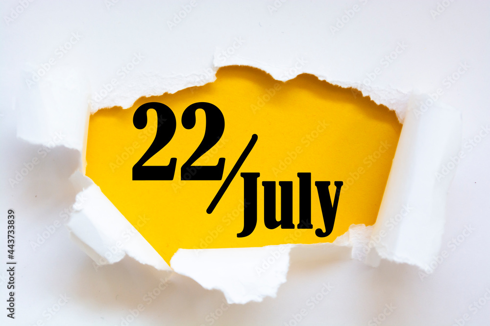 July 22. 22th day of the month, calendar date. Hole in paper with edges ...