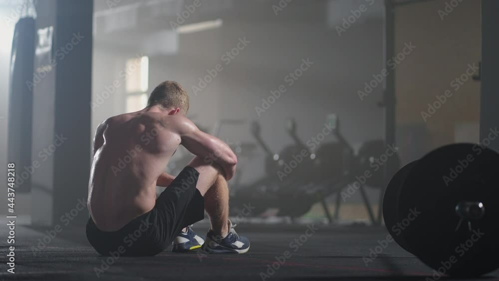 Exhausted young men resting after intensive workout in gym. Fitness ...