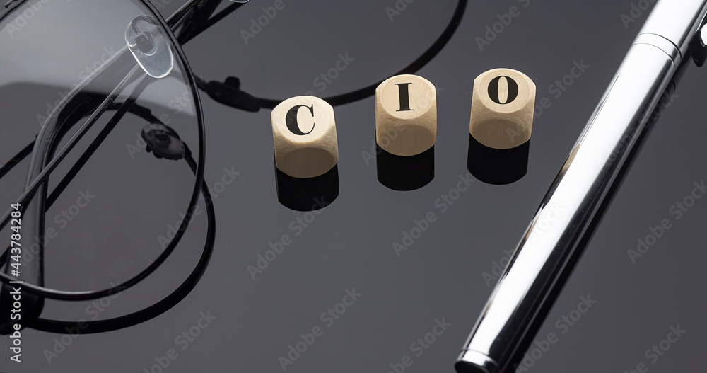 CIO concept, words on wooden blocks on the black background with pen ...