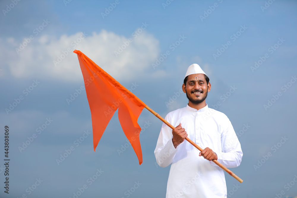 Young indian man (pilgrim) in traditional wear and waving religious ...