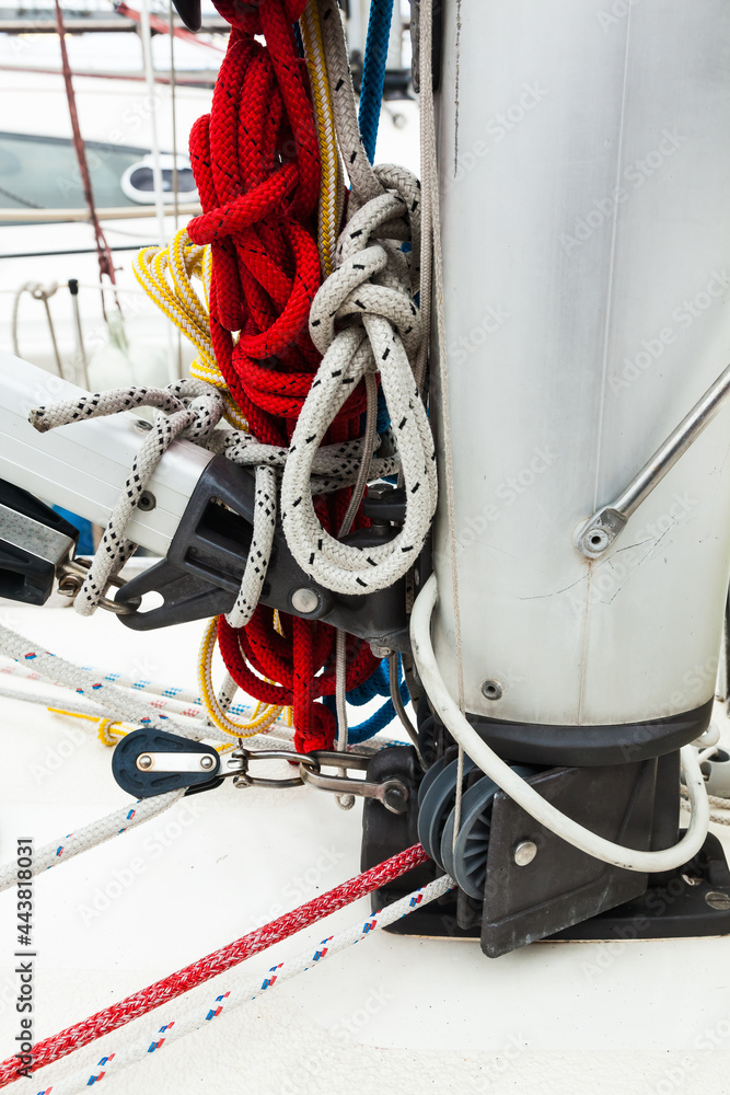The ropes are tied to the mast of a sailing ship, close-up. The ...