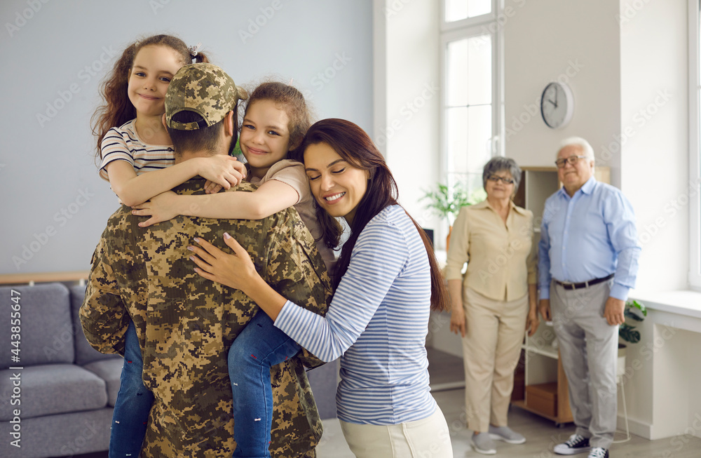 Military homecoming. Large family meets its hero. Happy military father ...