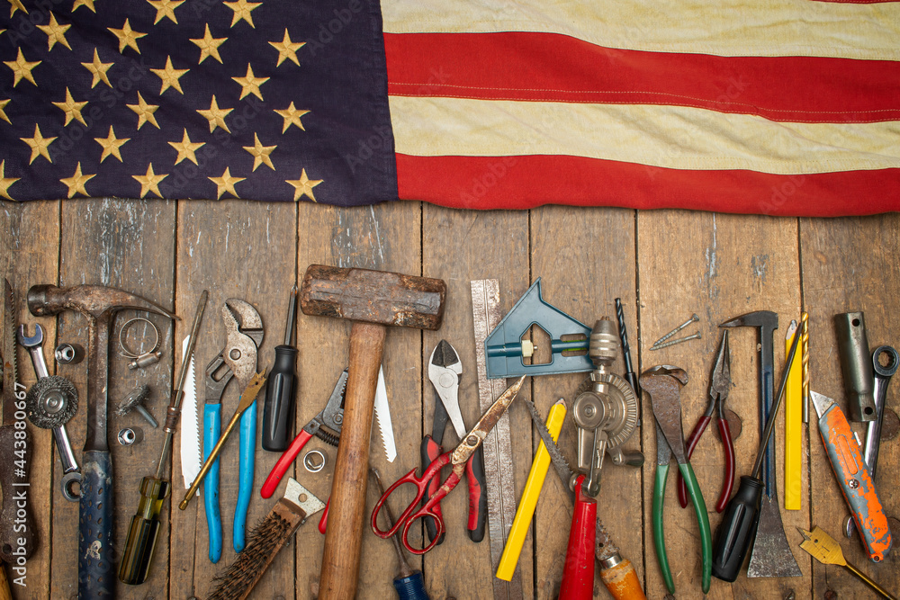Antique American flag above a set of tools on a old workbench Stock ...