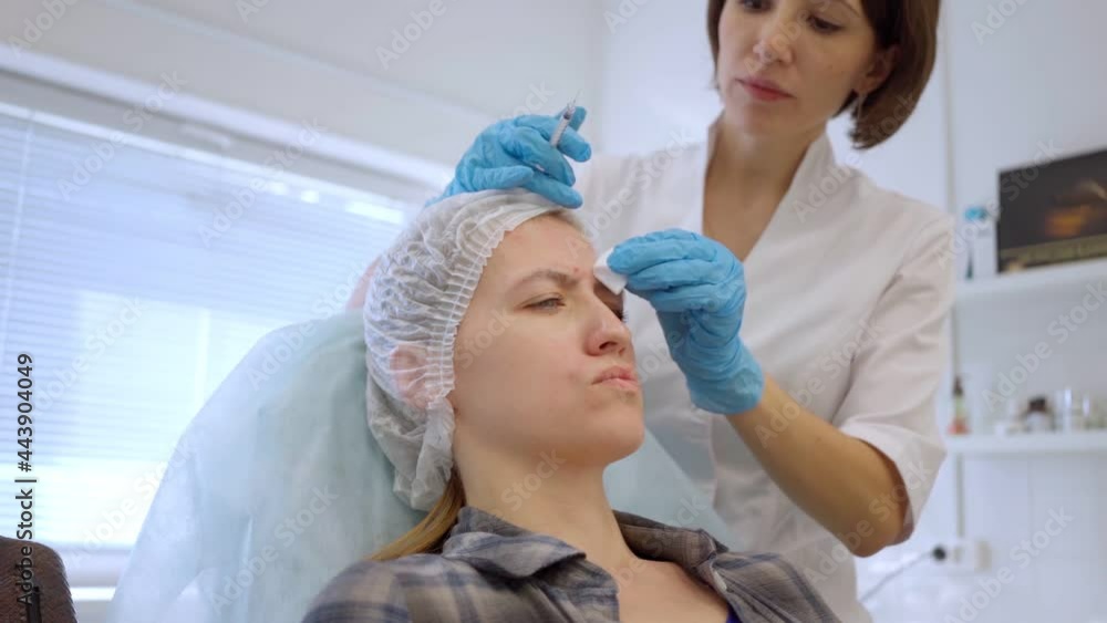 girl injected with botulin into skin of face. rejuvenating procedure in ...