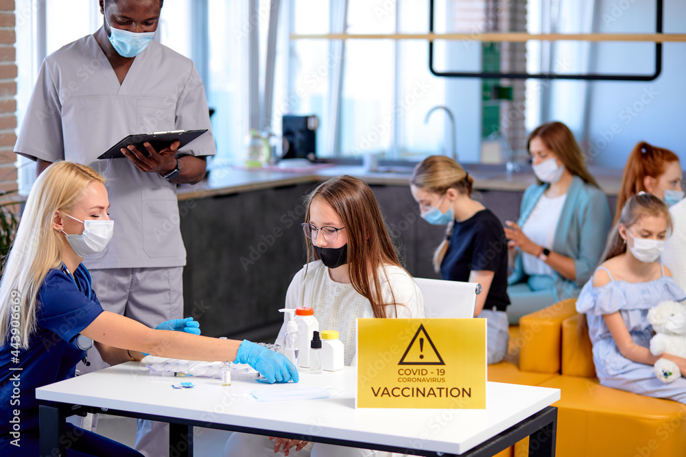 Mass vaccination and immunization. Professional female nurse giving an ...