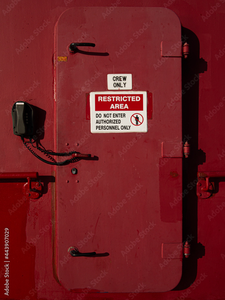 Restricted area red door. Do not enter. Authorized personnel only. Crew ...