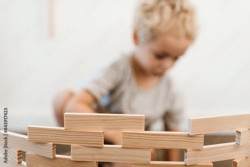 Young boy stacking wooden building blocks on top of each other Stock ...
