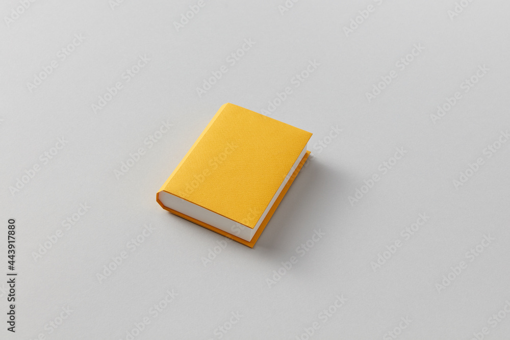 Yellow papercraft book on gray background Stock Photo | Adobe Stock