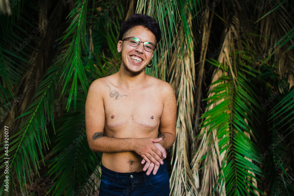 Young transgender man smiling in nature Stock Photo | Adobe Stock