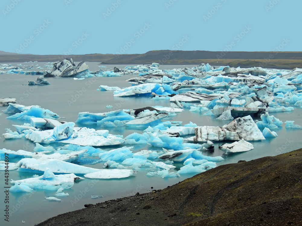 large blue icebergs floating at jokulsarlon along the ring road in ...