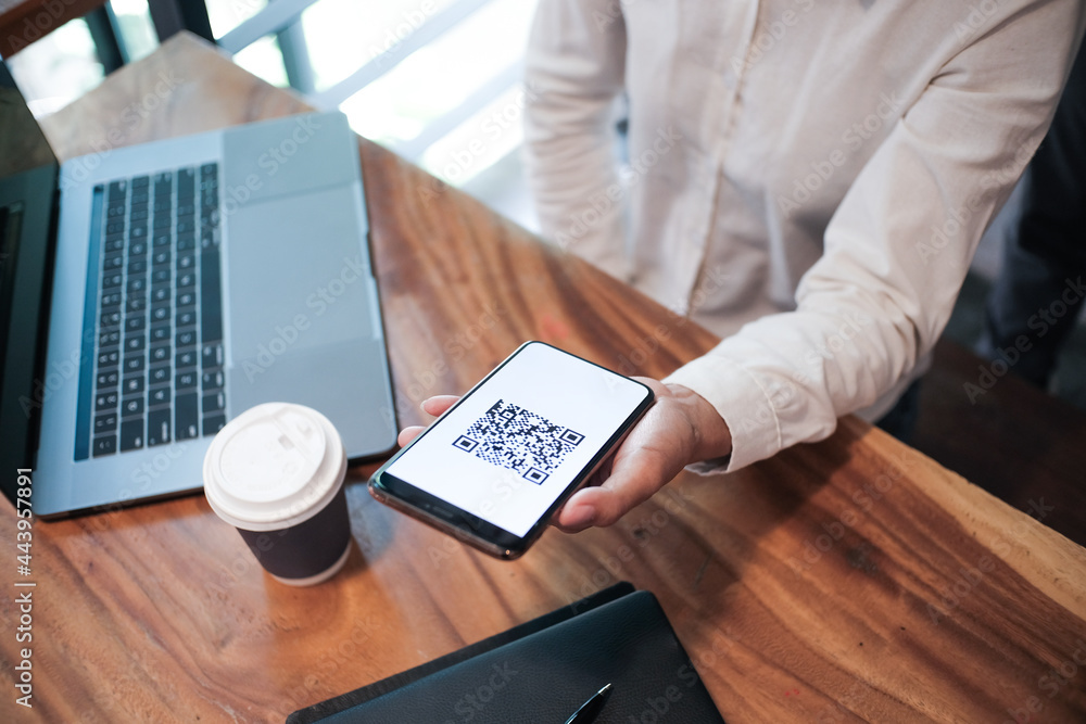 Qr code payment. Woman scanning QR code online shopping cashless ...