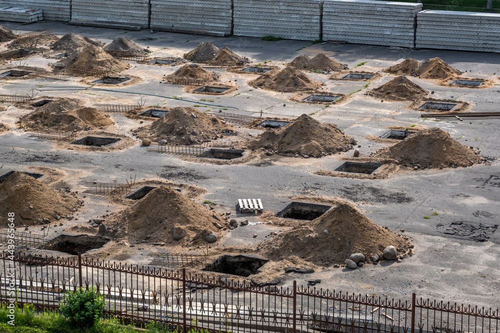 rows of pits at a construction site. preparation of the site for the ...