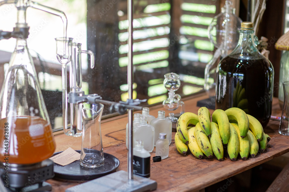 a selective focus bananas with glass jar filled juice in the laboratory ...