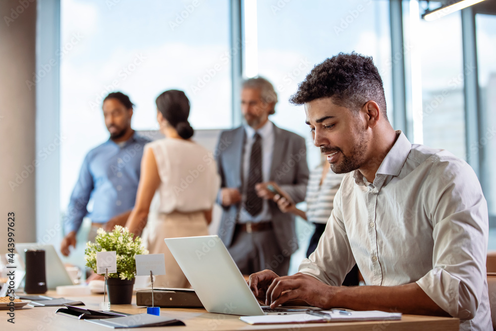 Successful leaders build successful teams. Businessman Using Laptop At ...