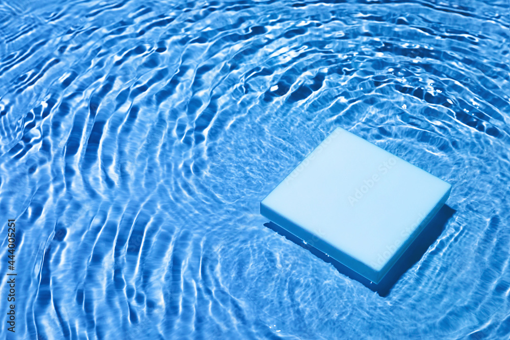 Empty white square podium on transparent clear dark blue water texture ...