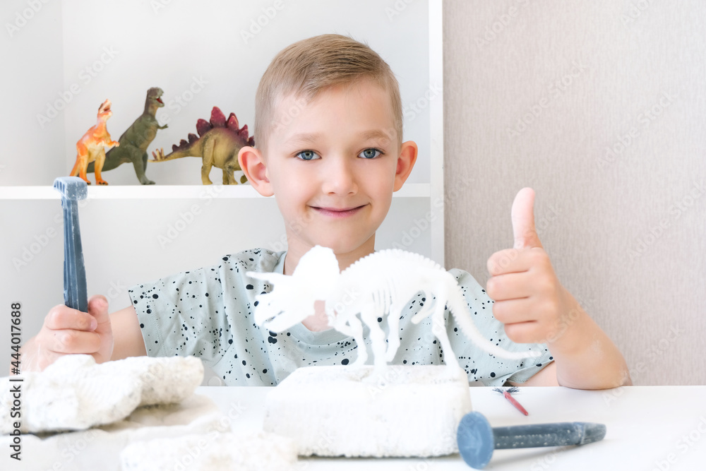 boy is engaged in the excavation of dinosaurs. Educational game with ...
