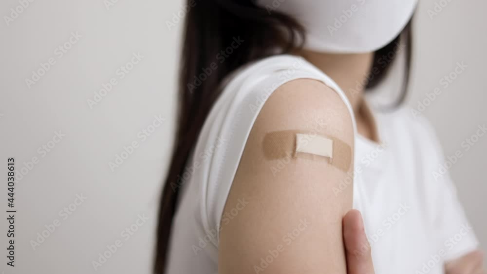Close up arm woman with plaster bandage after receiving vaccination ...