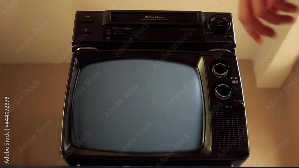 Man Hand putting VHS Into VCR and Old TV Green Screen. You can replace ...