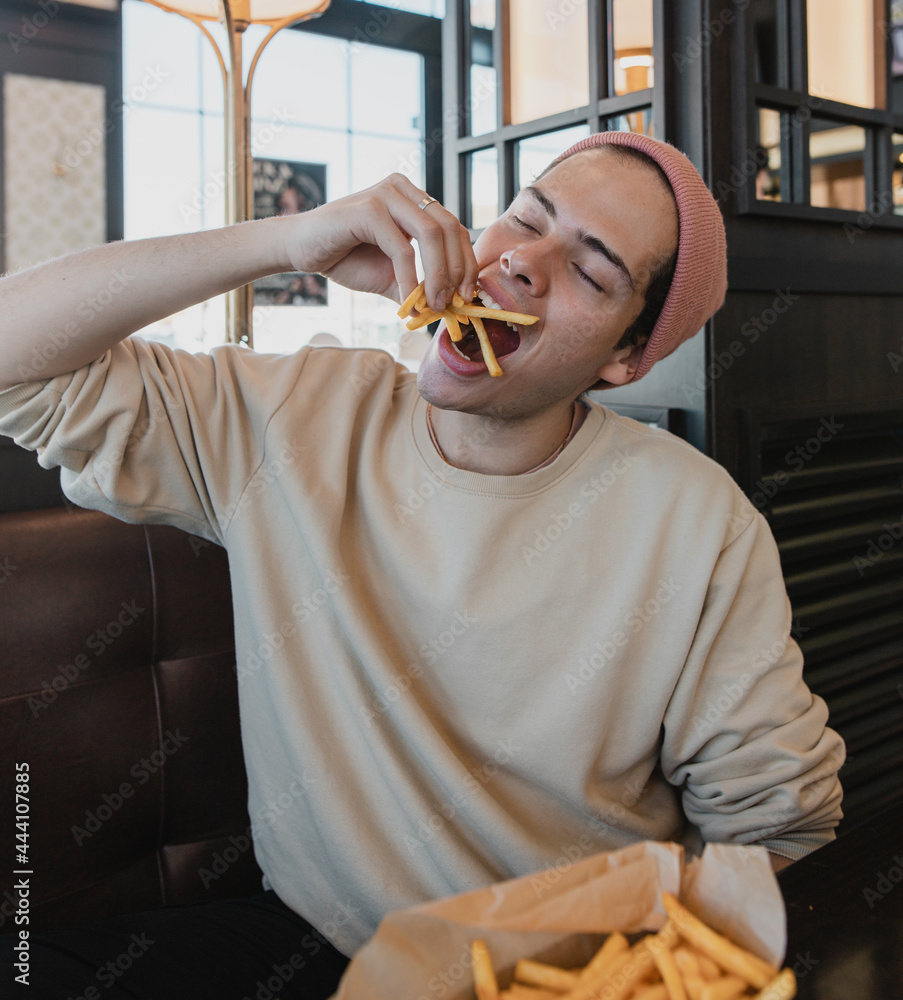 Man eating potato chips Stock Photo | Adobe Stock