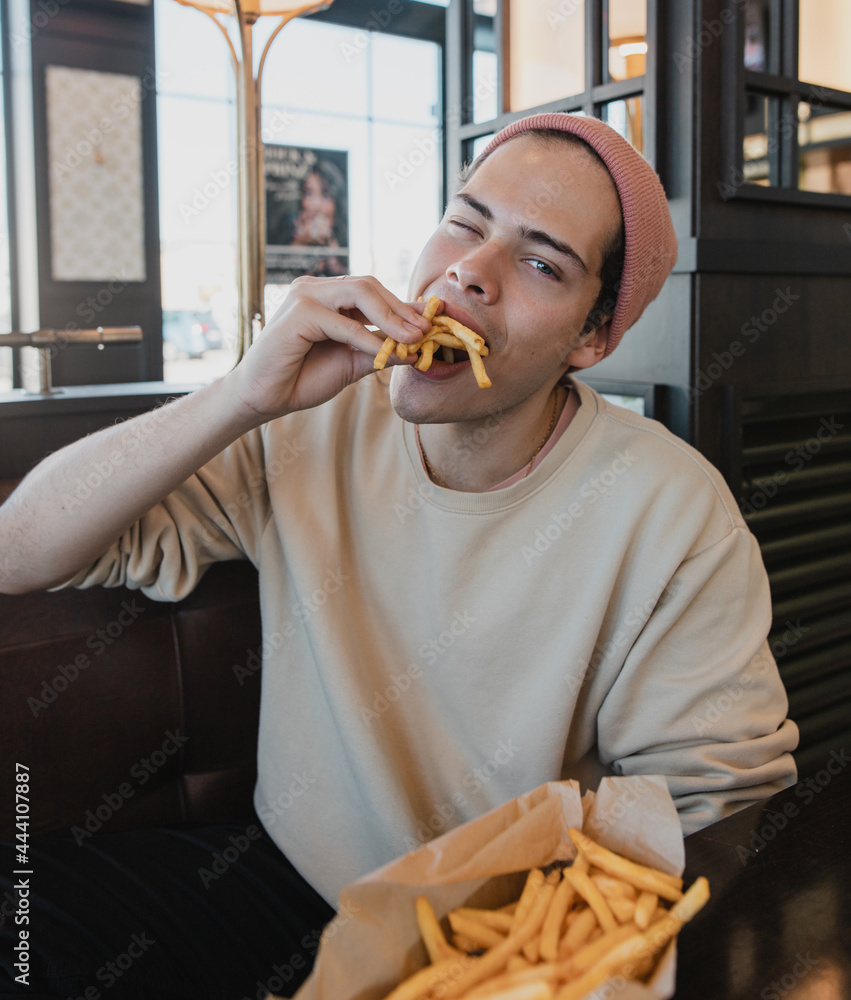Man eating potato chips Stock Photo | Adobe Stock