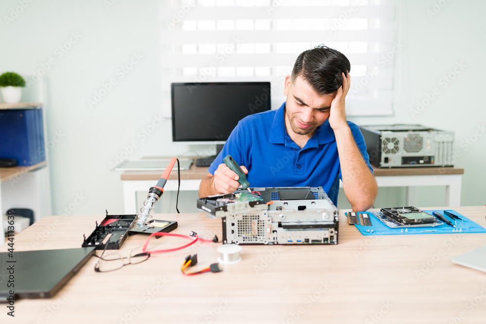 Upset young man does not know how to fix a CPU Stock Photo | Adobe Stock