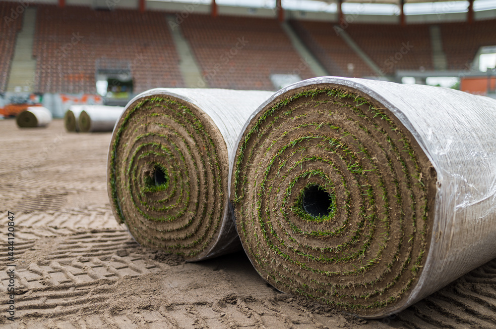 Big rolls of grass lays on a football field at the stadium. Stock Photo ...