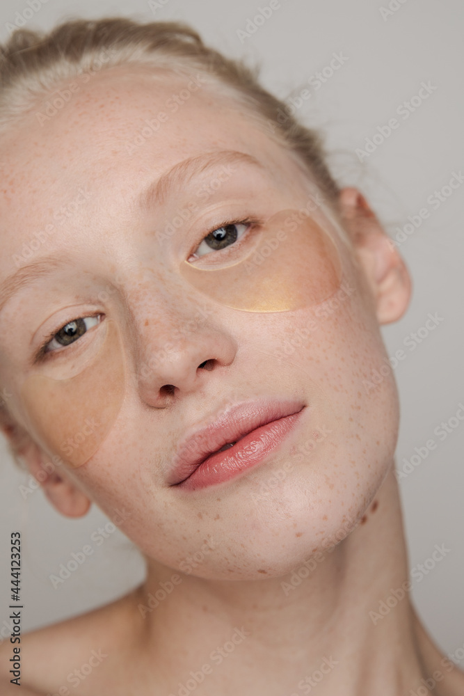 Young freckled model with golden under-eye patches Stock Photo | Adobe ...